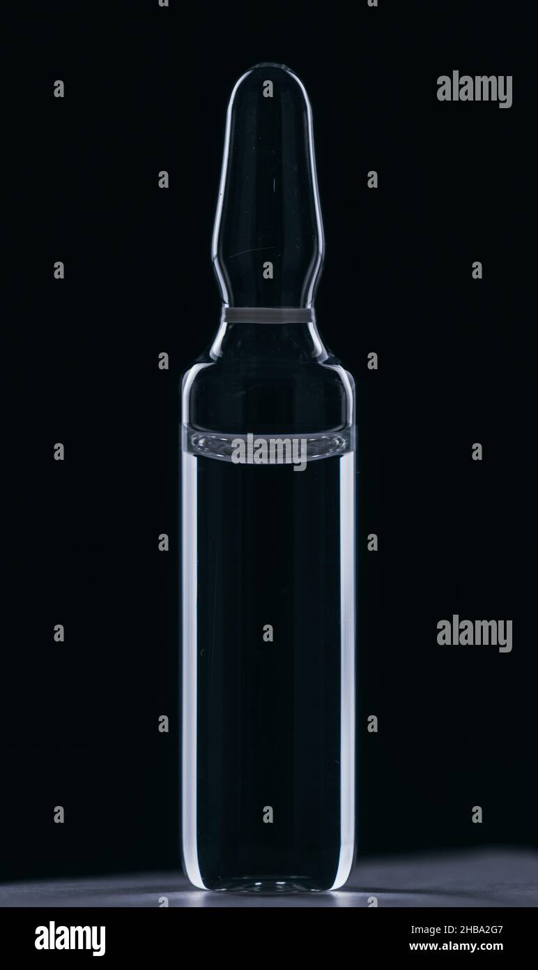 Glass medical ampoule vial for injection. Medicine is dry white drug ...