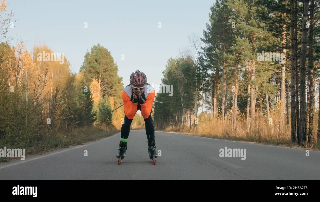 Training an athlete on the roller skaters. Biathlon ride on the roller ...