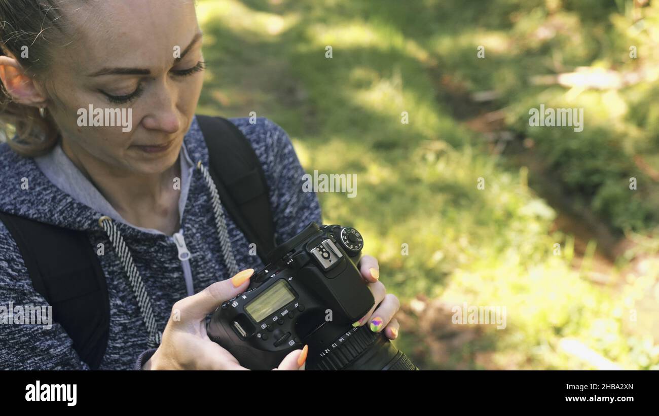 Traveler photographing scenic view in forest. One caucasian woman ...