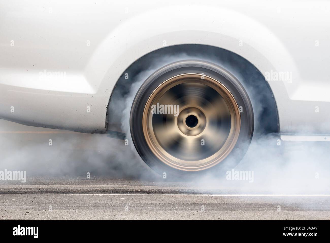 race car burns rubber off its tires in preparation for the race Stock ...
