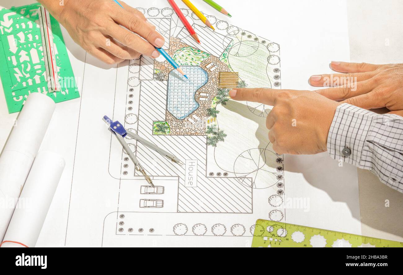 Landscape architect changing drawing at meeting with client Stock Photo ...