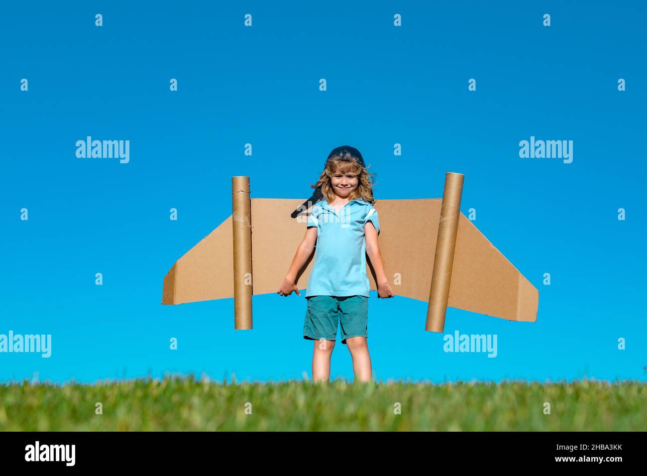 Kid with jet pack superhero. Child pilot against summer sky background ...