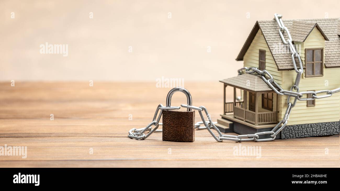 House tied with a chain and a closed lock. Concept ban on the sale of ...