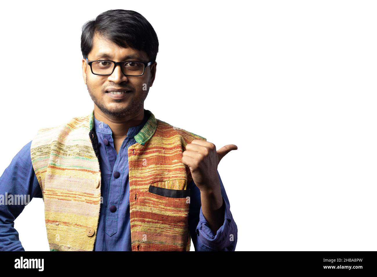 A young Indian male in blue dress pointing towards empty space on white ... A young Indian male in blue dress pointing towards empty space on white ...