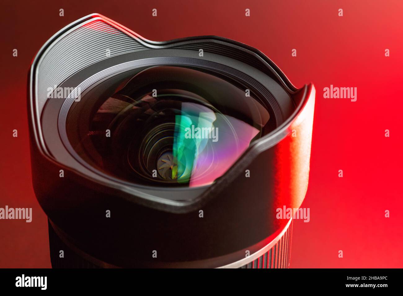 The camera lens with red light. Close-up of the camera lens on a black ...