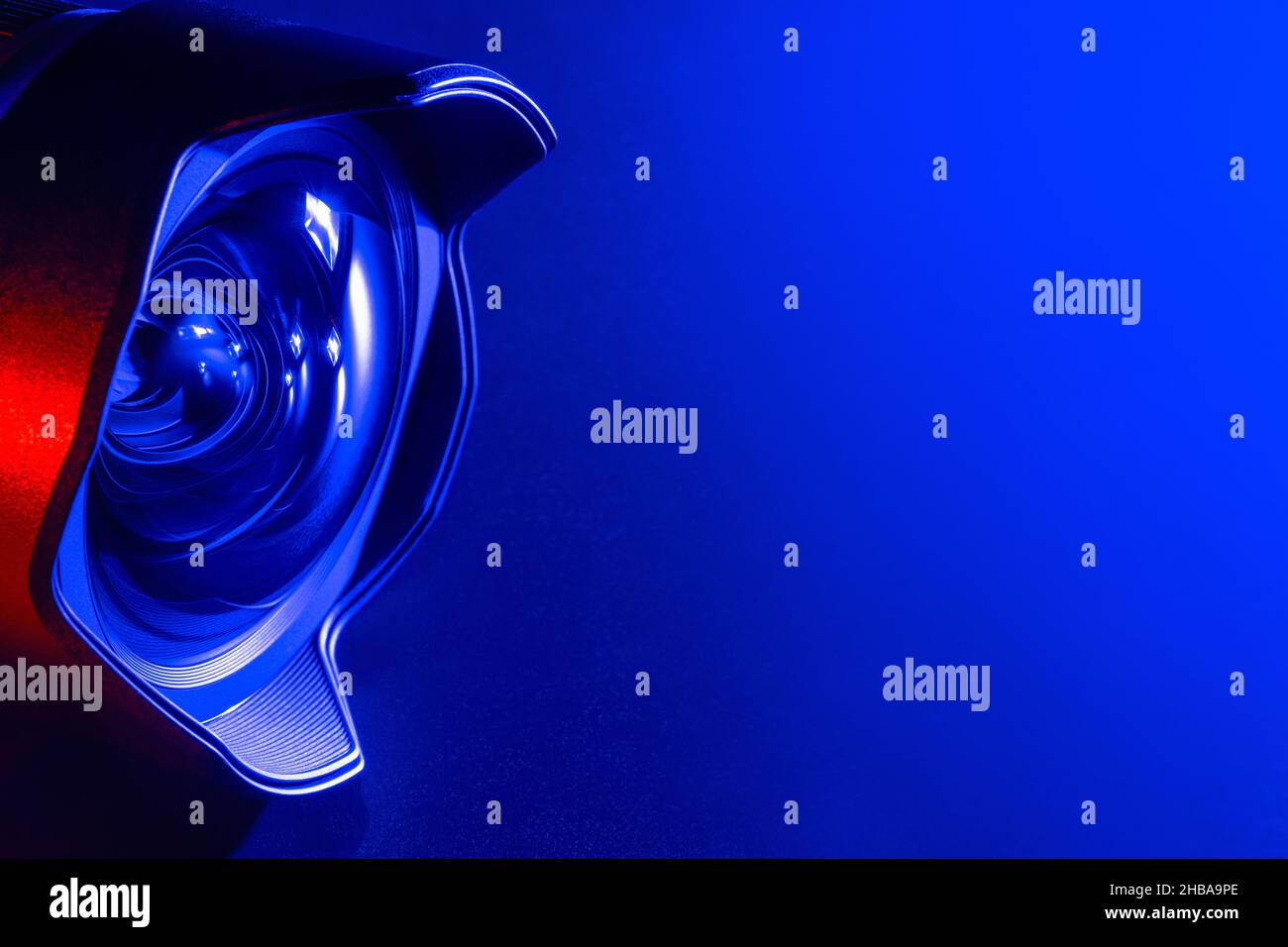 The camera lens blue and red backlight. Close-up of the camera lens on ...