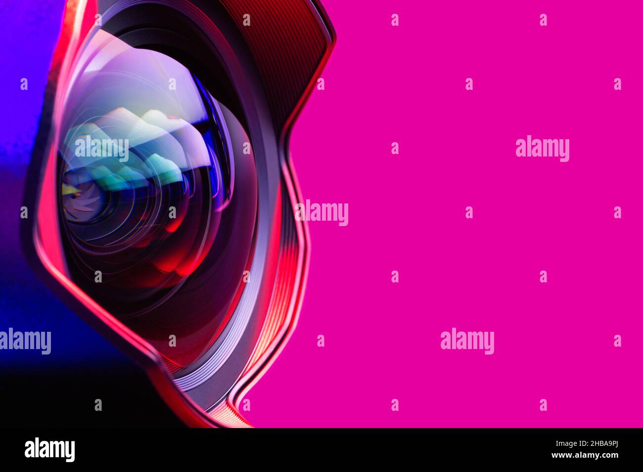The camera lens with bright pink and blue backlight. Close-up of the ...