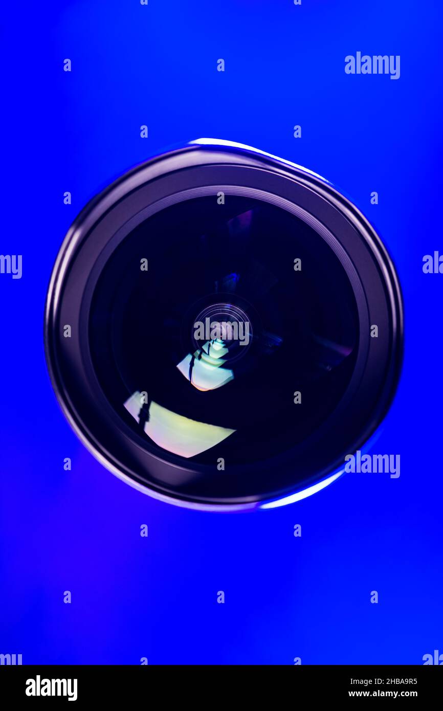 The camera lens with blue backlight. Optics. Vertical photo Stock Photo ...