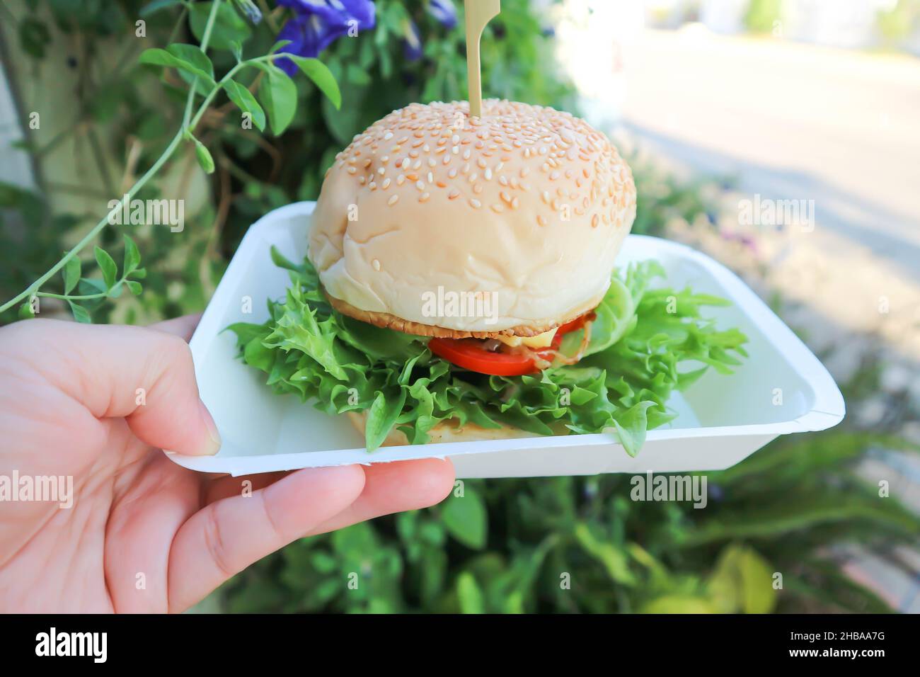 Handing burger hi-res stock photography and images - Alamy