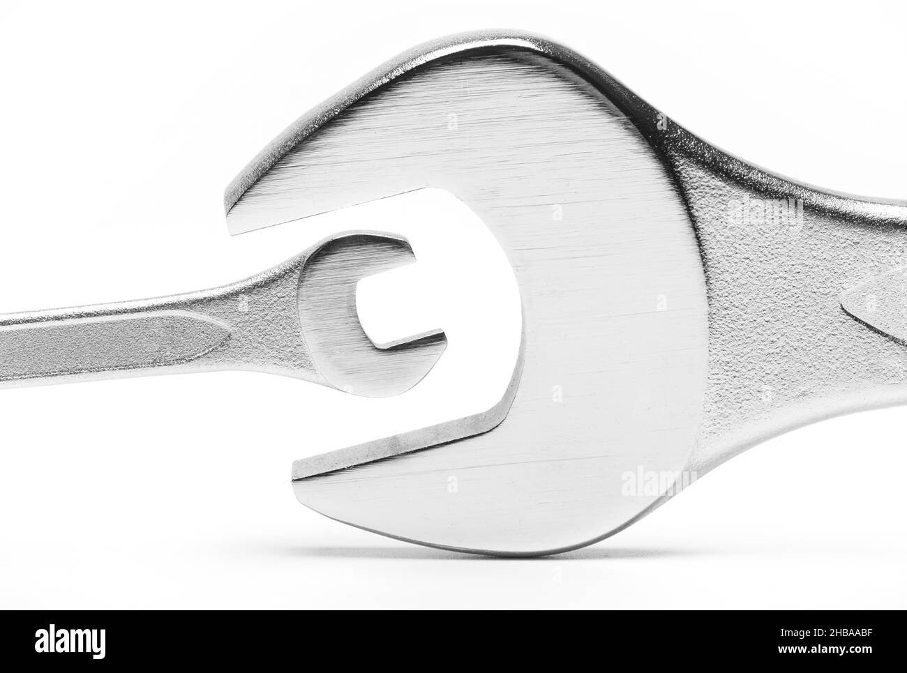 Close up of very small open end wrench inside very large wrench as ...