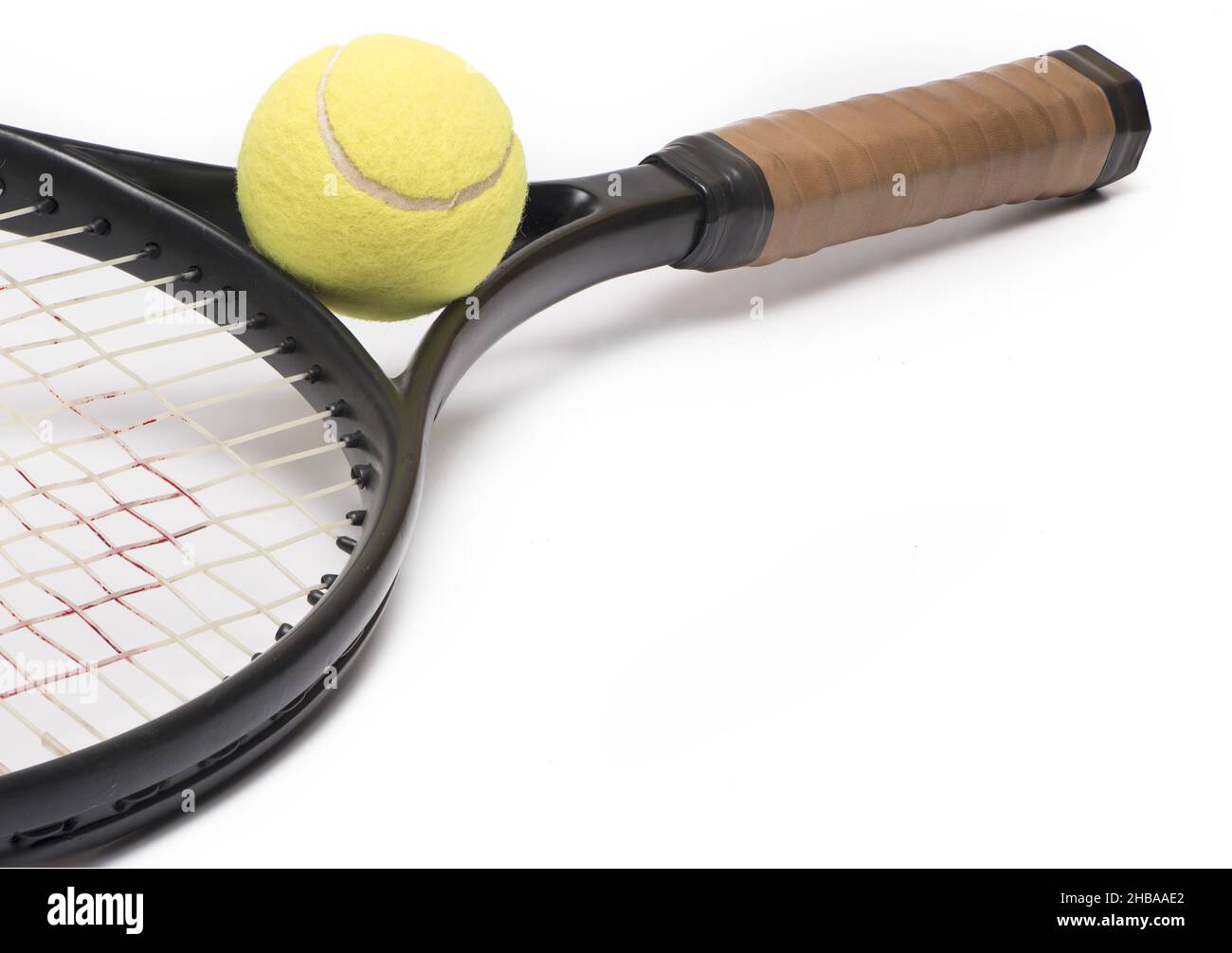 Close up of black tennis racket with brown leather handle strap and ...