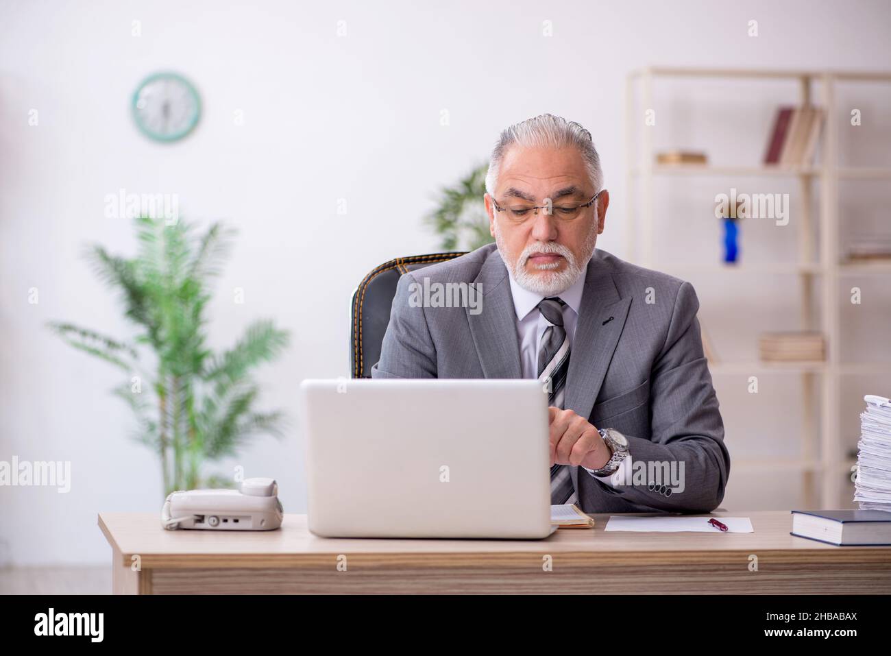 Old businessman employee and too much work at workplace Stock Photo - Alamy