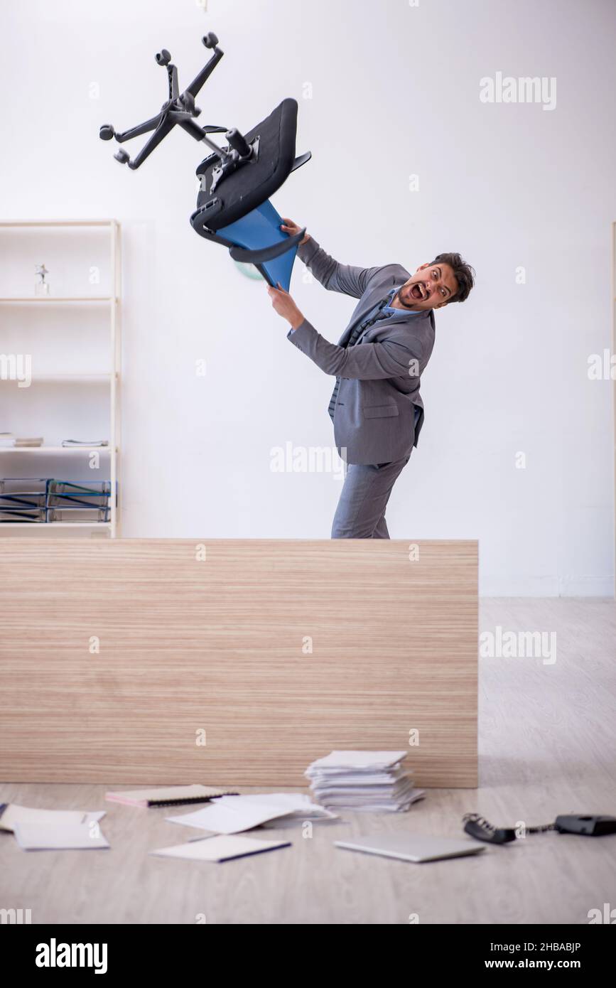 Young businessman employee working overtime at workplace Stock Photo ...