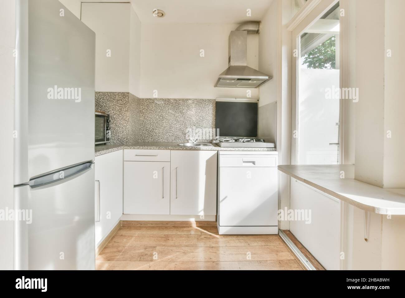 Small cozy modern kitchen with a window and a white kitchen unit Stock ...