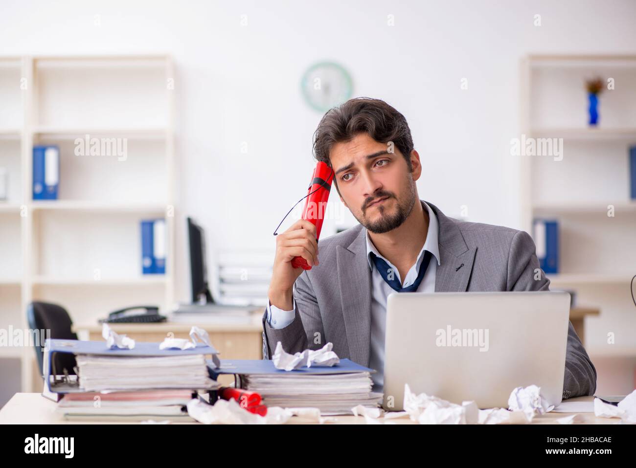 Young employee and too much work in the office Stock Photo - Alamy