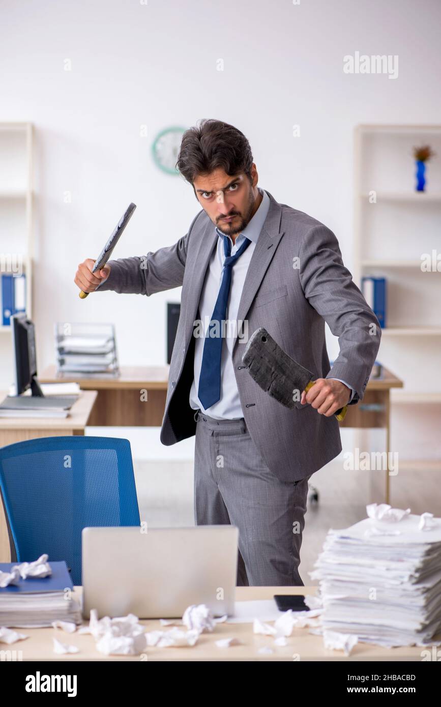 Young employee and too much work in the office Stock Photo - Alamy