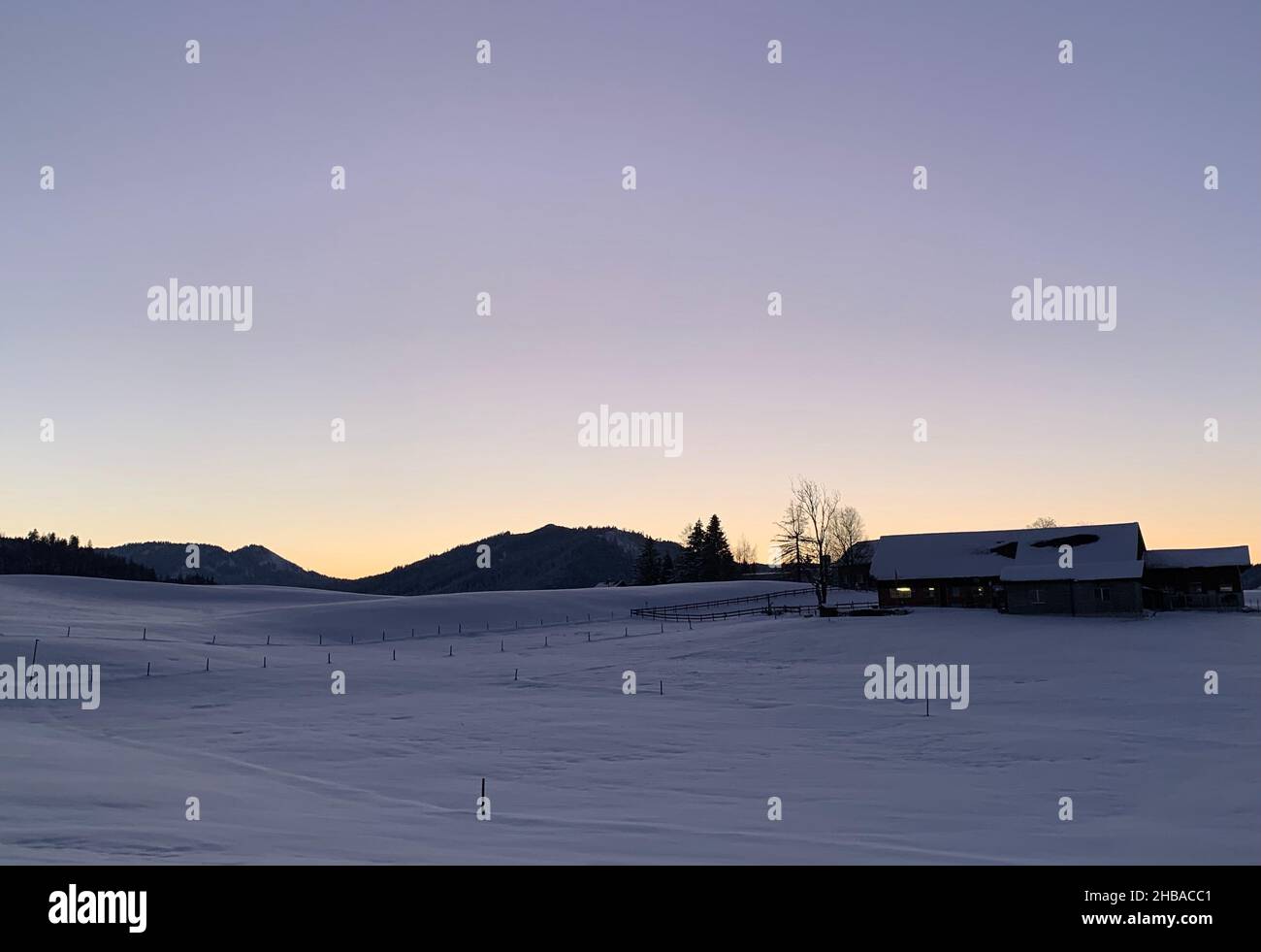 Sunset over snow covered landscape in Switzerland, canton Schwyz on a ...