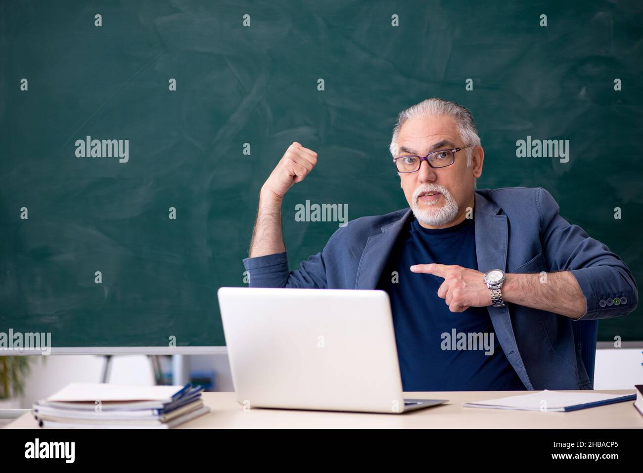 Old teacher in the classroom Stock Photo - Alamy