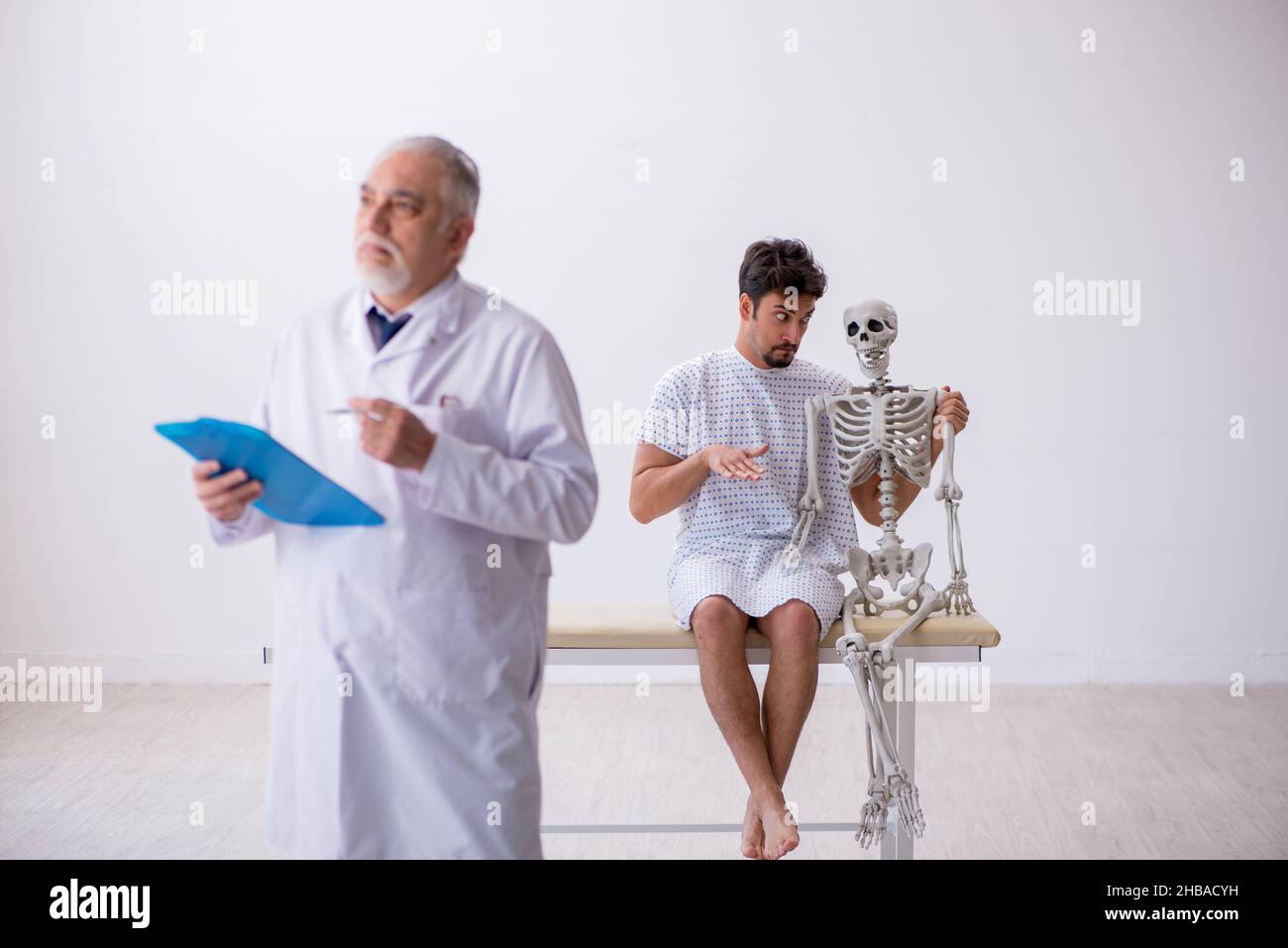 Old doctor psychiatrist examining young male patient Stock Photo - Alamy