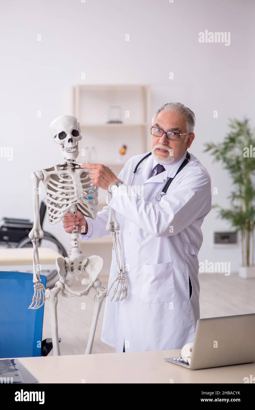 Old doctor demonstrating human skeleton Stock Photo - Alamy