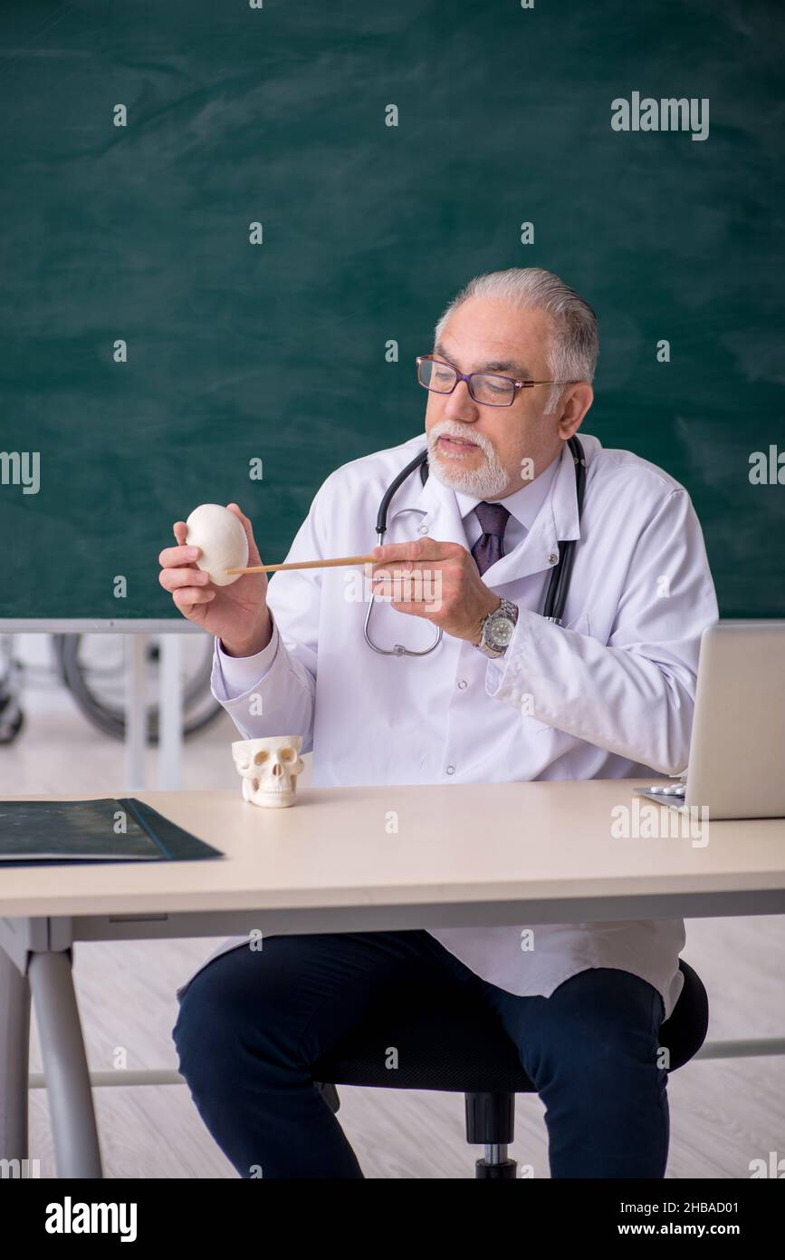 Old doctor teacher in front of blackboard Stock Photo - Alamy