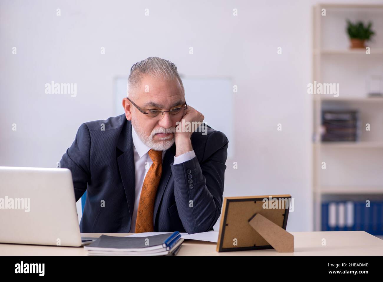 Old businessman employee missing his wife at workplace Stock Photo - Alamy