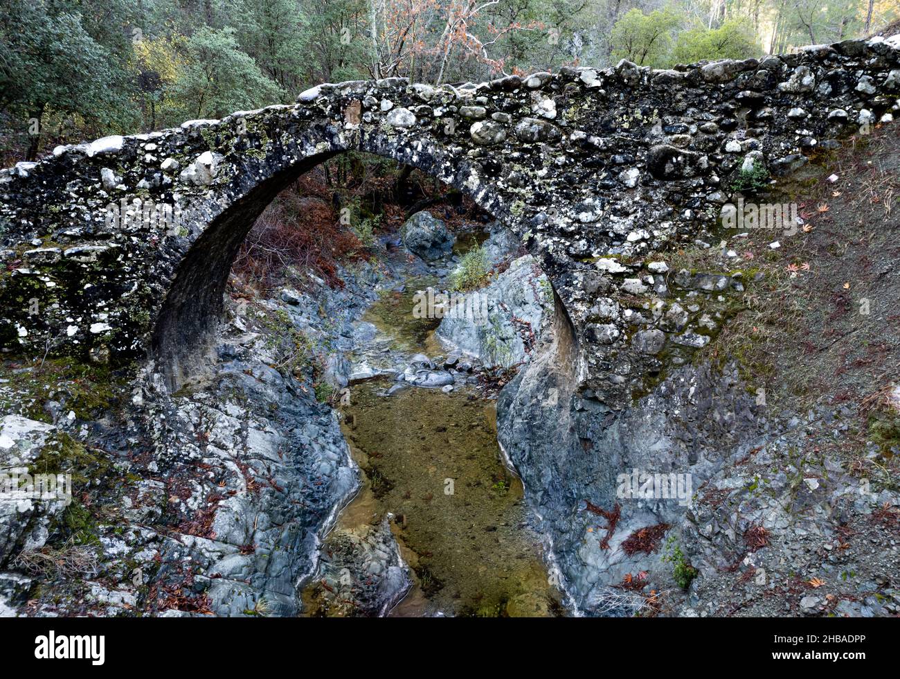 Aerial drone photograph of a medieval stoned bridge with water flowing ...