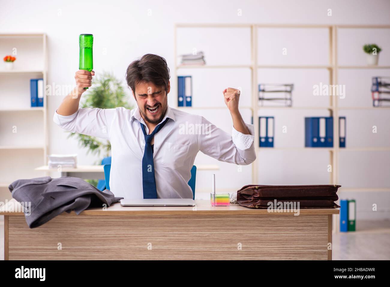 Male alcohol addicted employee sitting in the office Stock Photo - Alamy