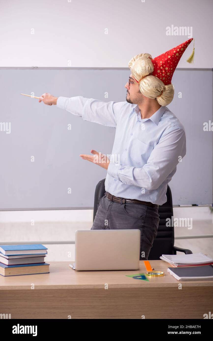 Funny young teacher magician in the classroom Stock Photo - Alamy