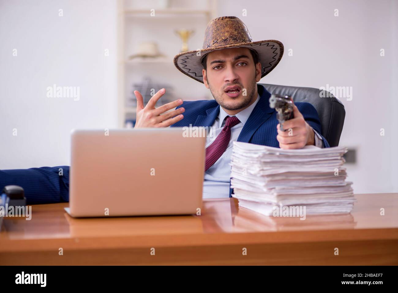 Young cowboy employee working at workplace Stock Photo - Alamy