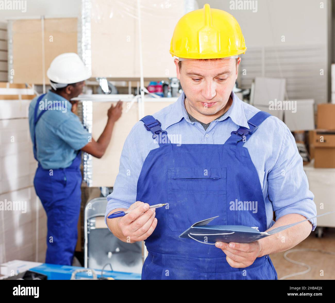 Construction worker planning upcoming repairs Stock Photo - Alamy
