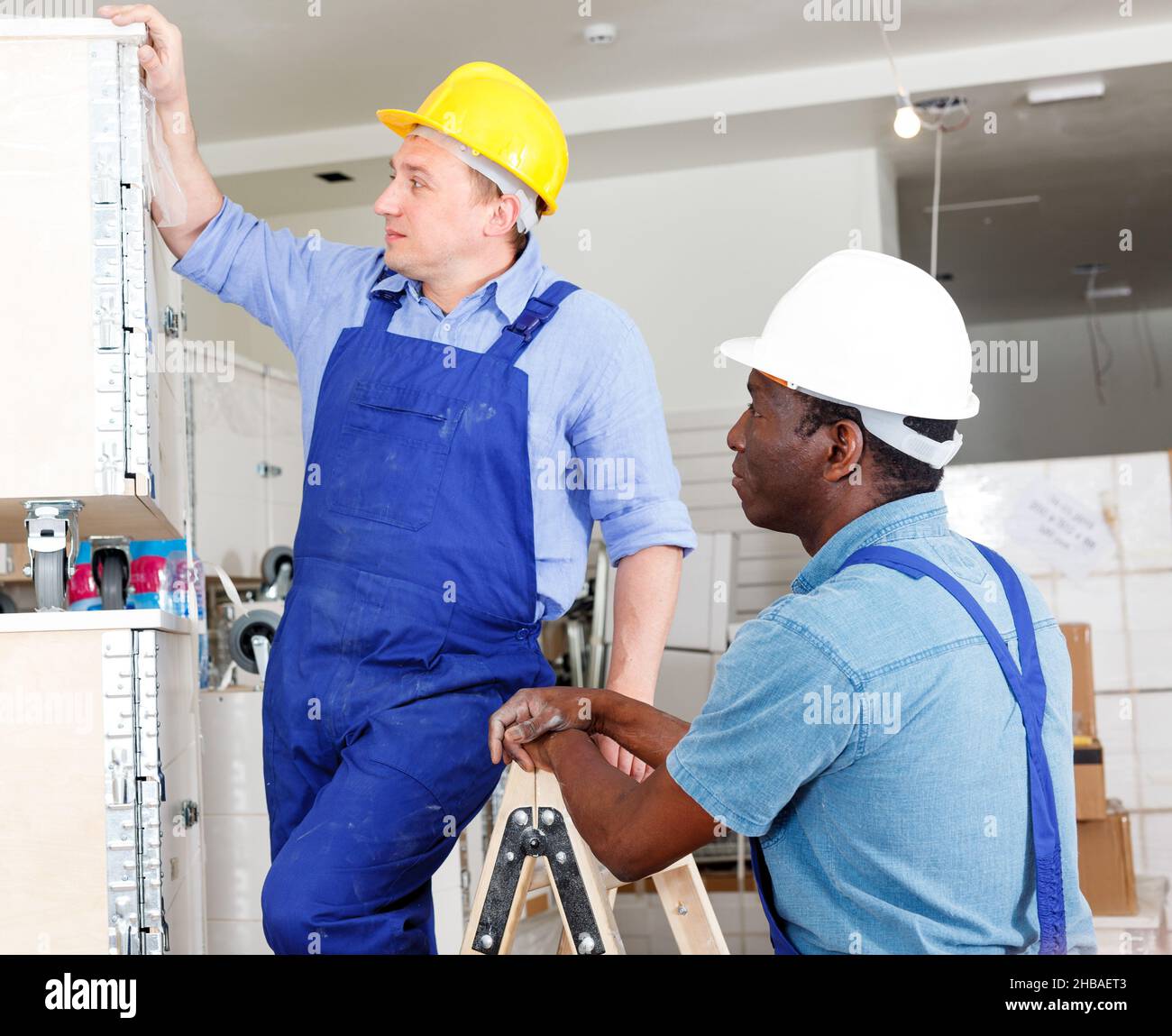 Builders working indoors Stock Photo - Alamy