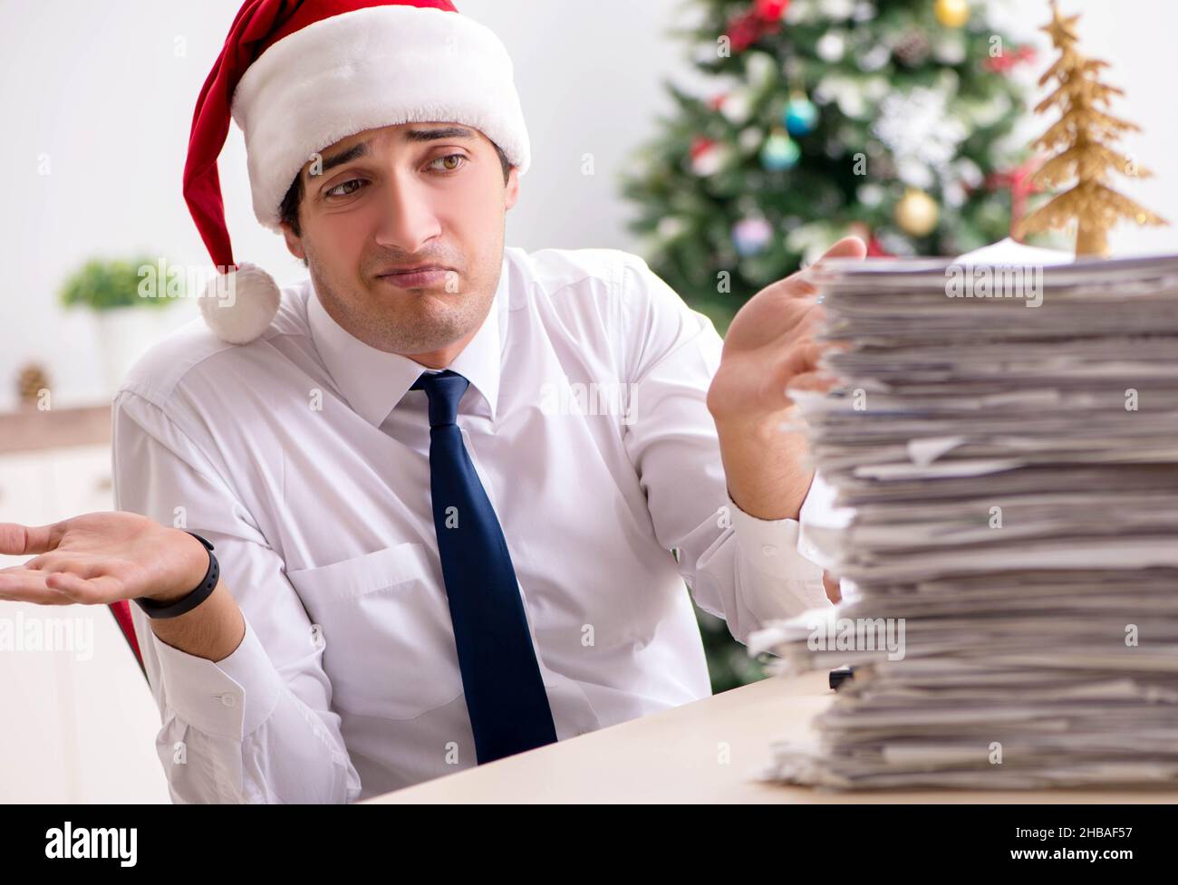 The young worker working in office on christmas shift Stock Photo - Alamy