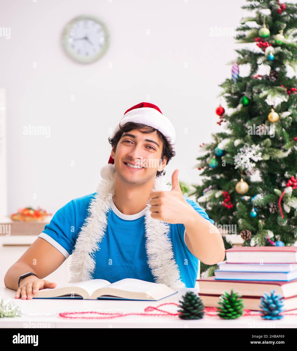 The young student with book at christmas eve Stock Photo - Alamy