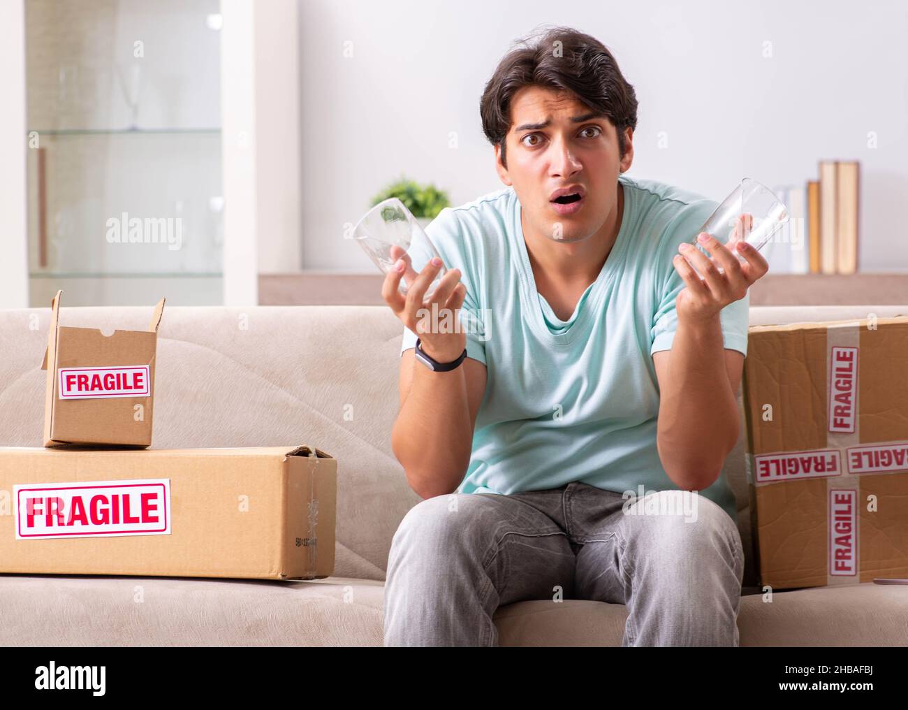 The man opening fragile parcel ordered from internet Stock Photo - Alamy