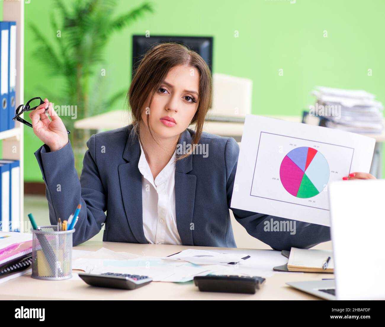 Female financial manager presenting graph chart sitting in the office ...