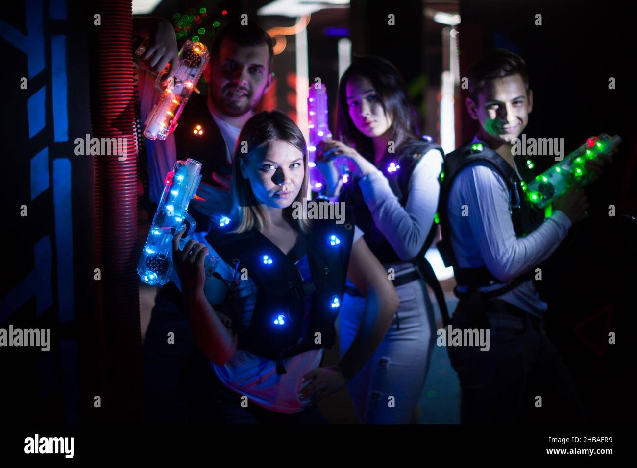 Young people with laser guns on lasertag arena Stock Photo - Alamy