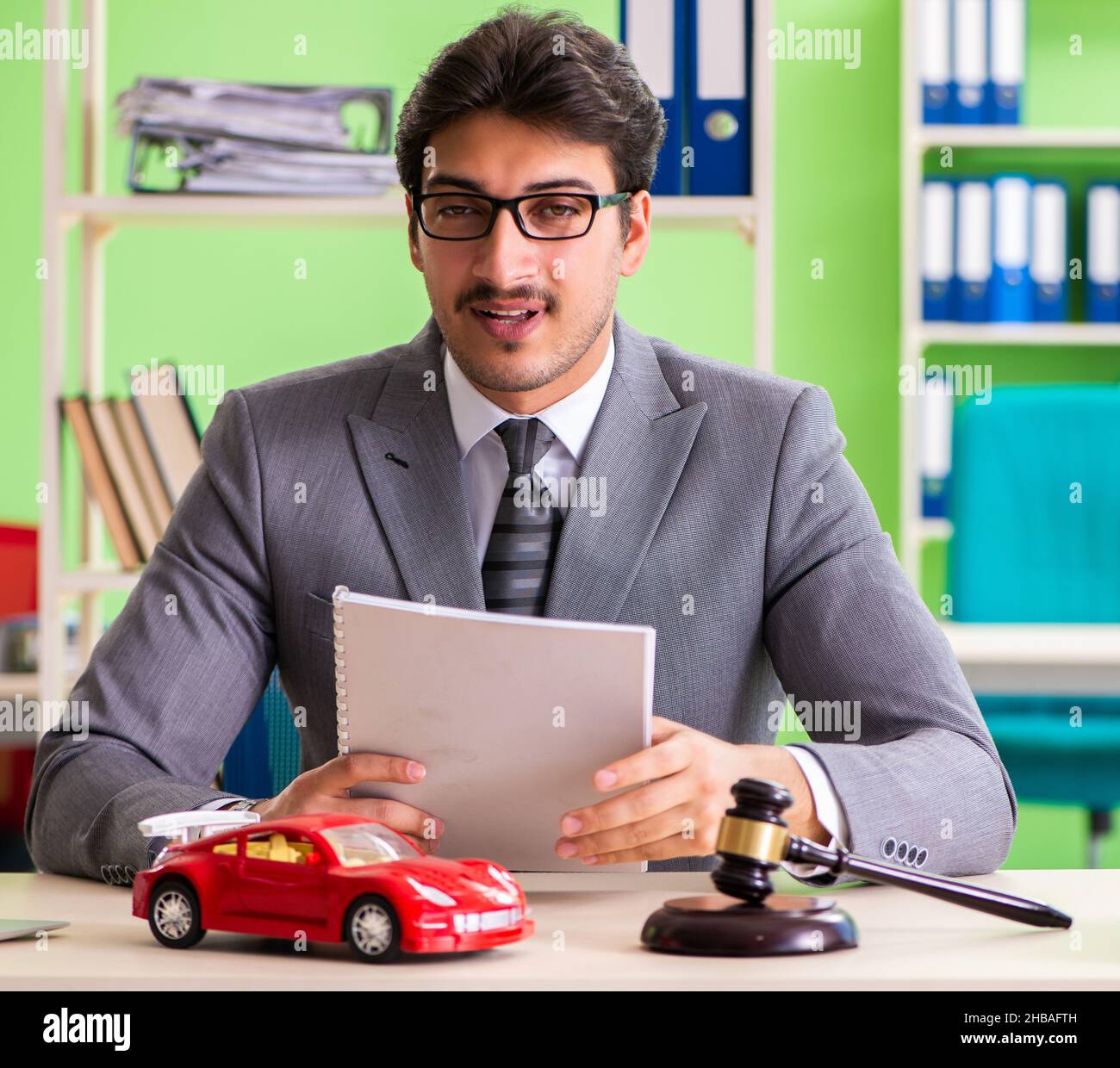 The young handsome lawyer working in the office Stock Photo - Alamy