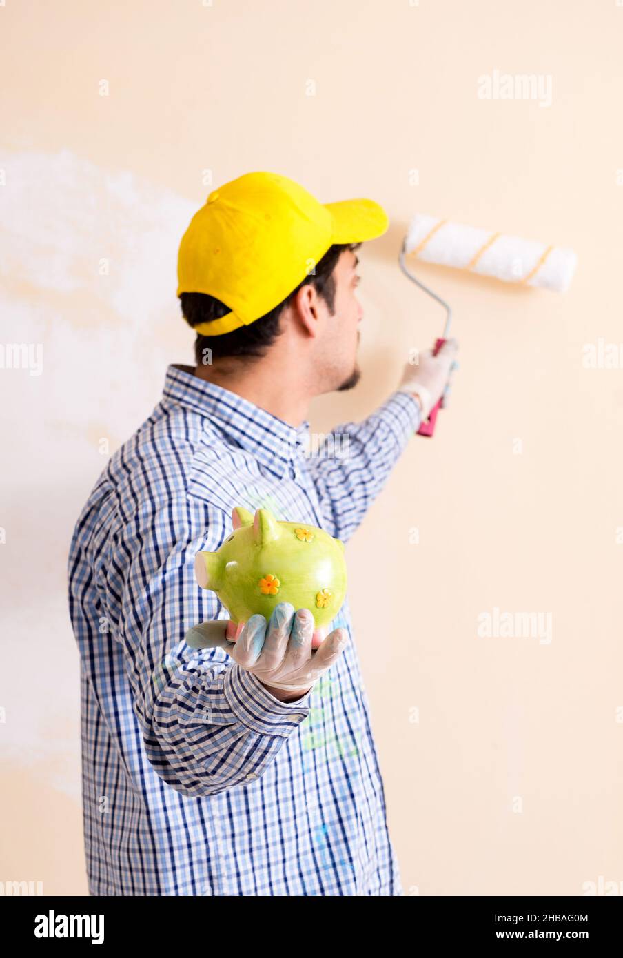 The painter man painting the wall at home Stock Photo - Alamy