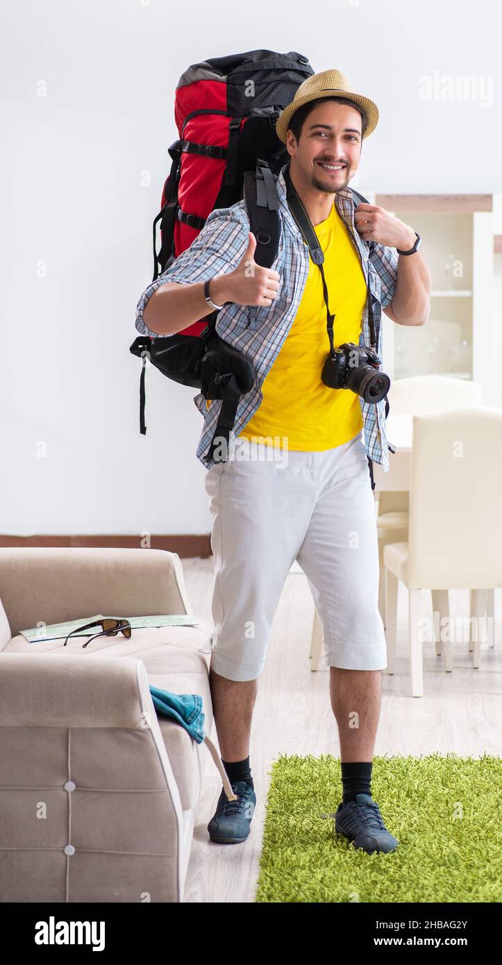 The backpacker packing for his trip Stock Photo - Alamy