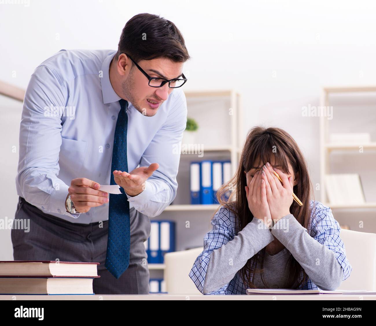 The male lecturer giving lecture to female student Stock Photo - Alamy