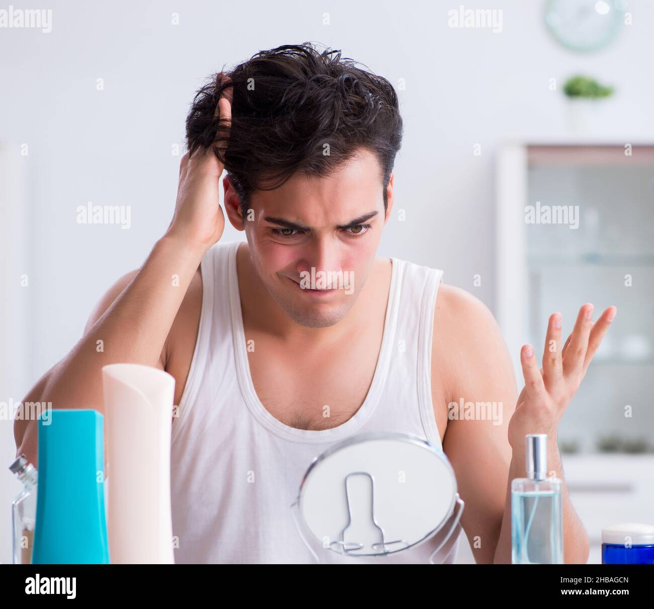 The young handsome man staring in the mirror Stock Photo - Alamy