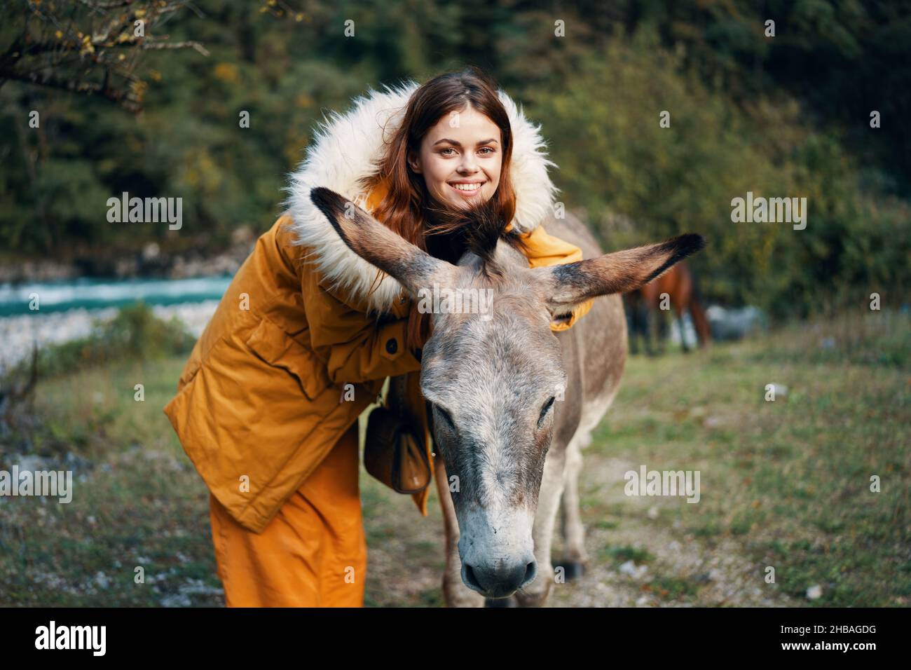 woman outdoors next to donkey travel walk lifestyle Stock Photo - Alamy
