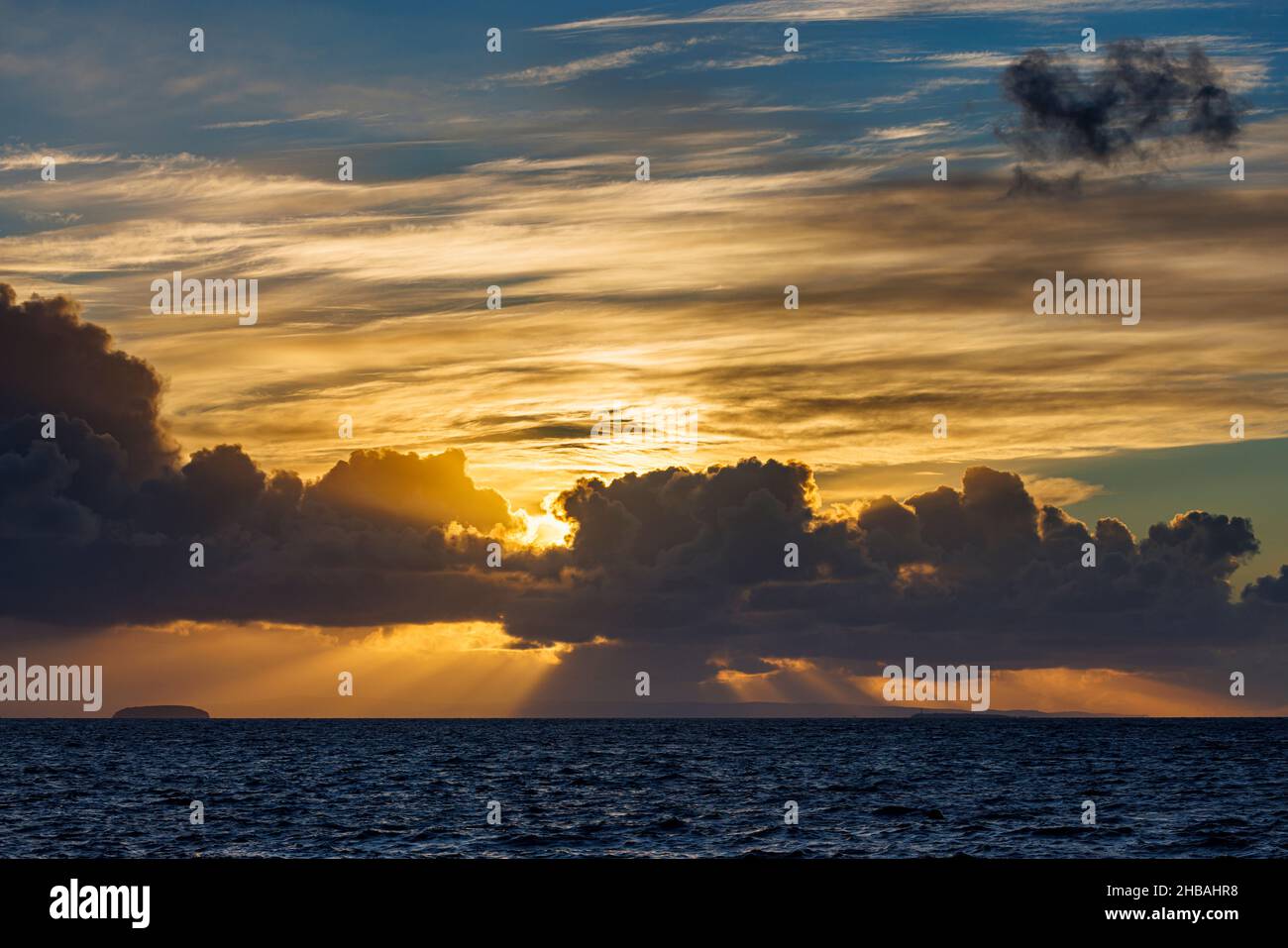 The setting sun lighting up the cloud cover Stock Photo - Alamy