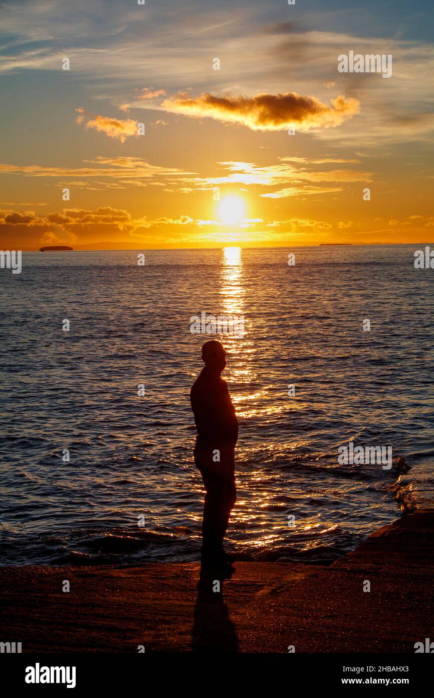 Silhouette of a person and a streak of sunlight Stock Photo - Alamy