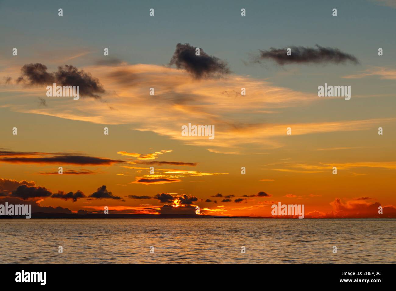 The setting sun lighting up the cloud cover Stock Photo - Alamy