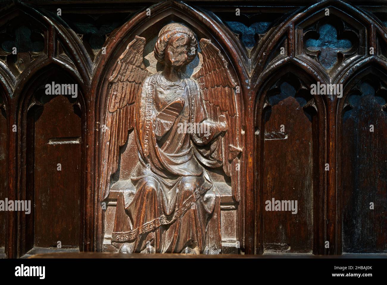 Defaced carving of an angel on the wooden bench in the choir at the ...