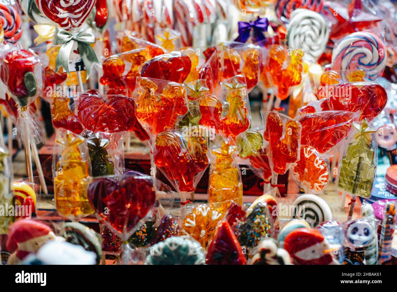 Bright red orange sweet lollipops cockerel figurines at Christmas ...