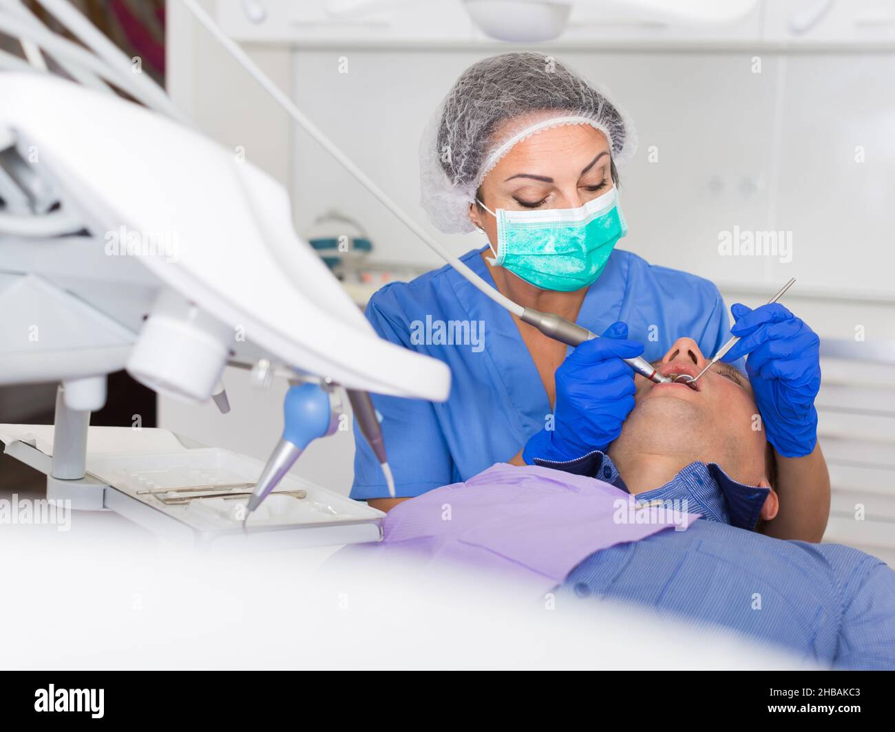 adult dentist checking teeth of patient Stock Photo - Alamy