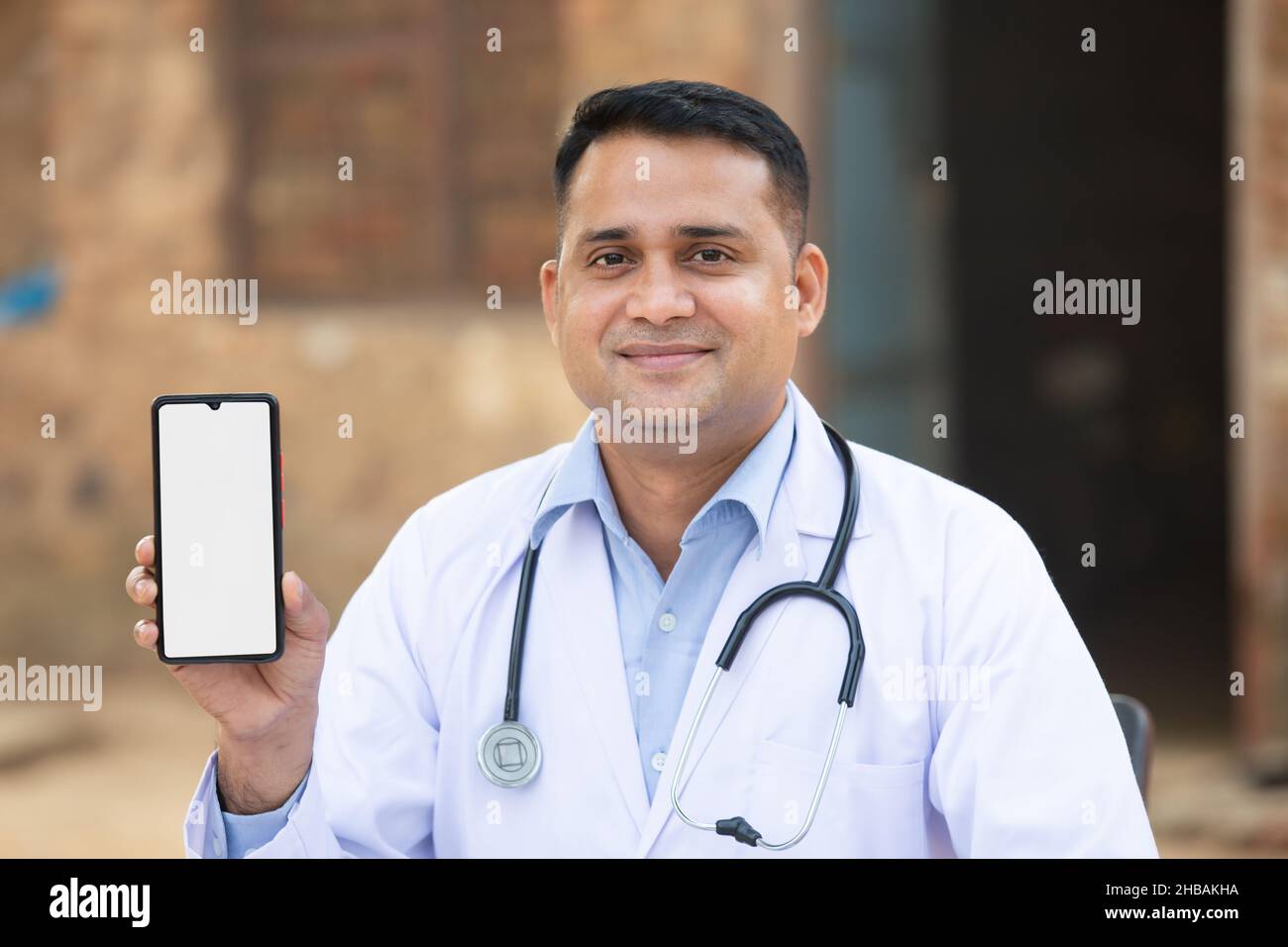 Young Positive Indian Male Doctor Wearing Stethoscope Showing Smart ...